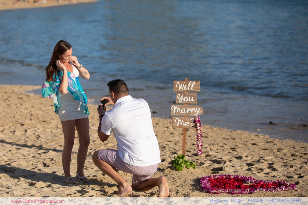 Surprise beach proposal with Diamond Head in the background, Hawaii