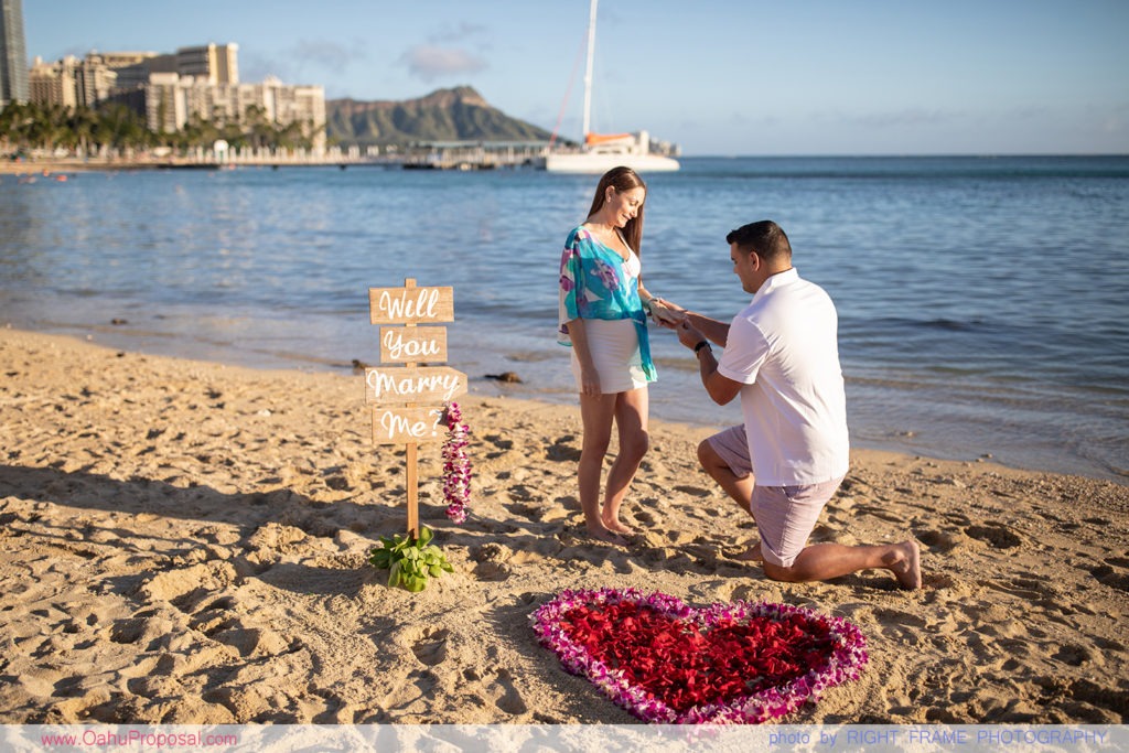Surprise beach proposal with Diamond Head in the background, Hawaii